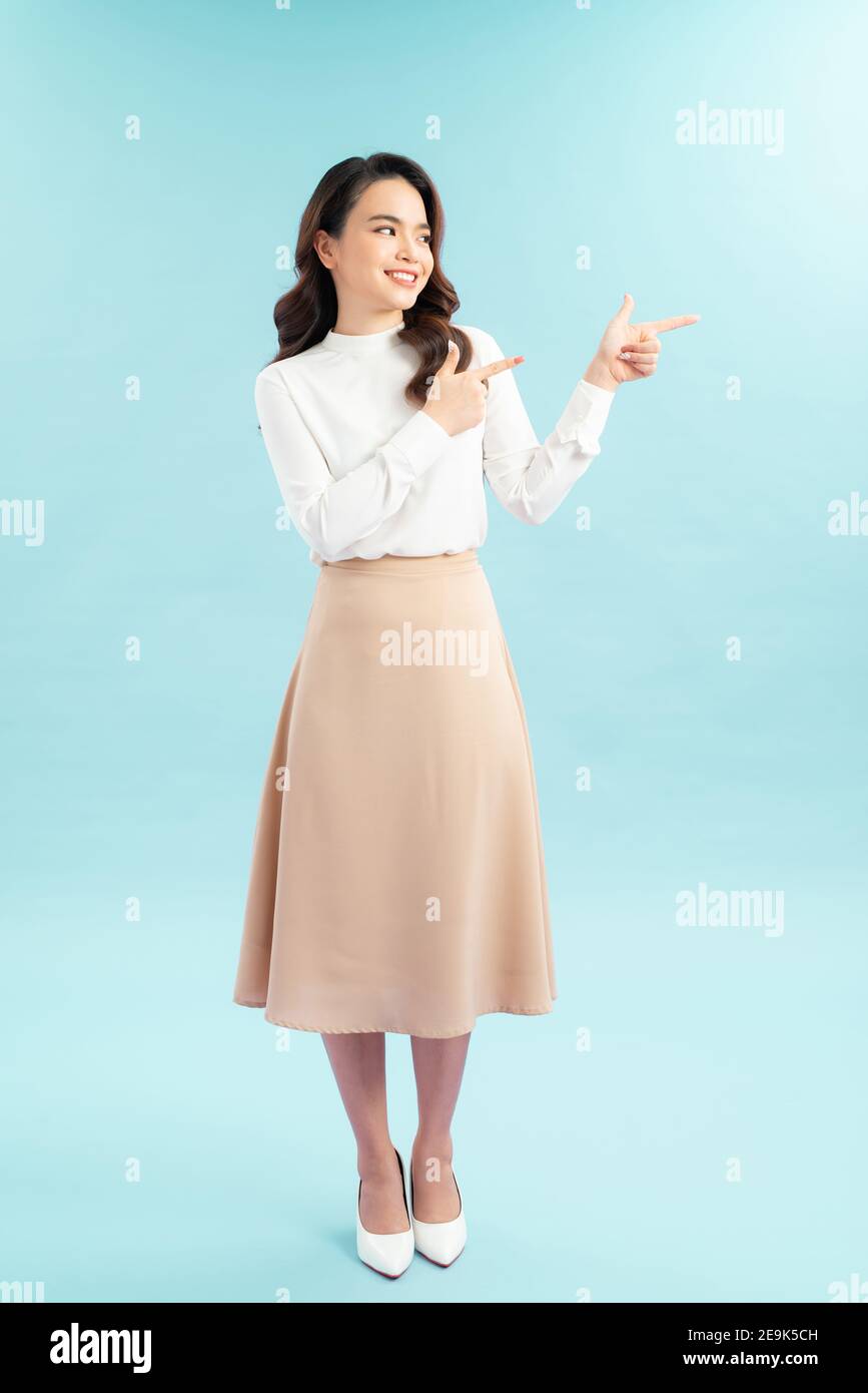 Satisfied young adult woman promote product, pointing recommendation ...