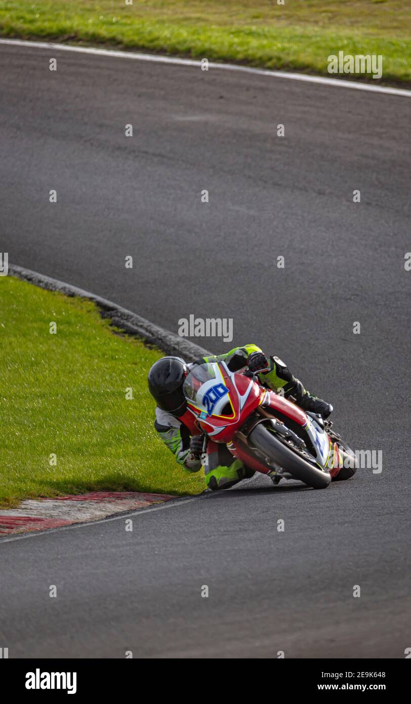 A shot of a racing motorbike as it circuits a track Stock Photo - Alamy