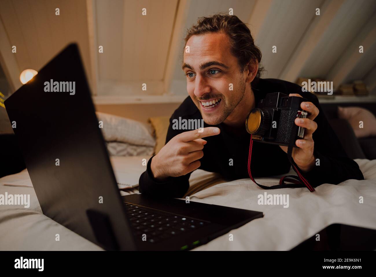 Caucasian male teen showing off new camera chatting to family on video ...