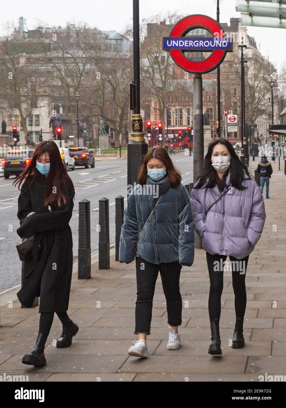 Women wearing a mask walk past Westminster Tube Station in Central ...