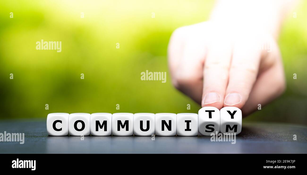 Hand turns dice and changes the word communism to community Stock Photo ...