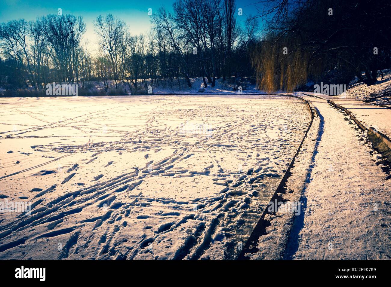 Frozen lake covered with snow in winter Stock Photo - Alamy