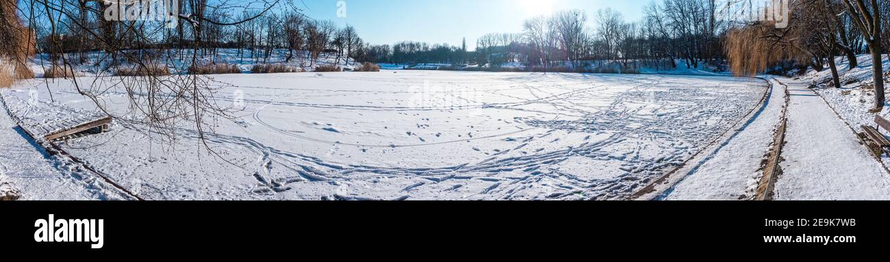 Frozen lake covered with snow in winter - panorama Stock Photo - Alamy