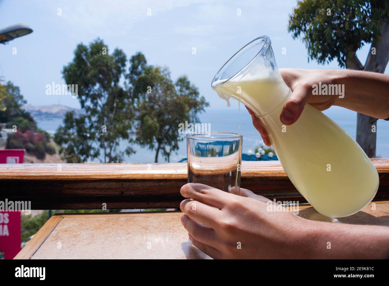 Hand grabbing a jar of Frozen lemonade and pouring it on a glass Stock ...