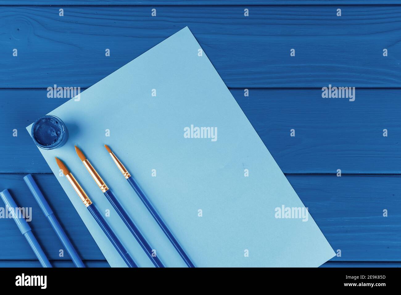 Blue paint brushes on classic blue background, view from above Stock ...