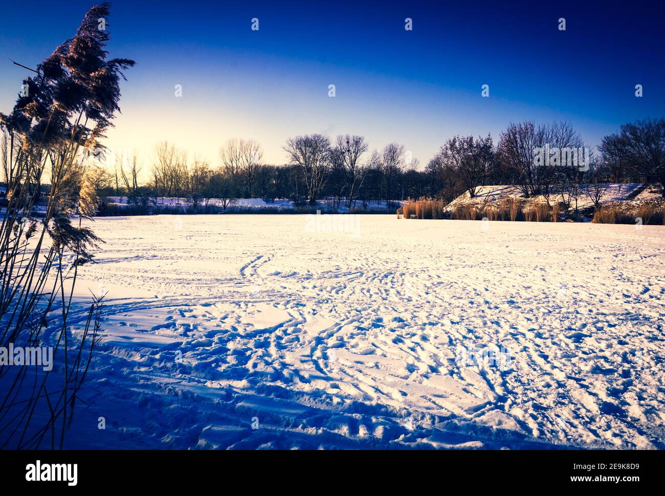 Frozen lake covered with snow in winter Stock Photo - Alamy