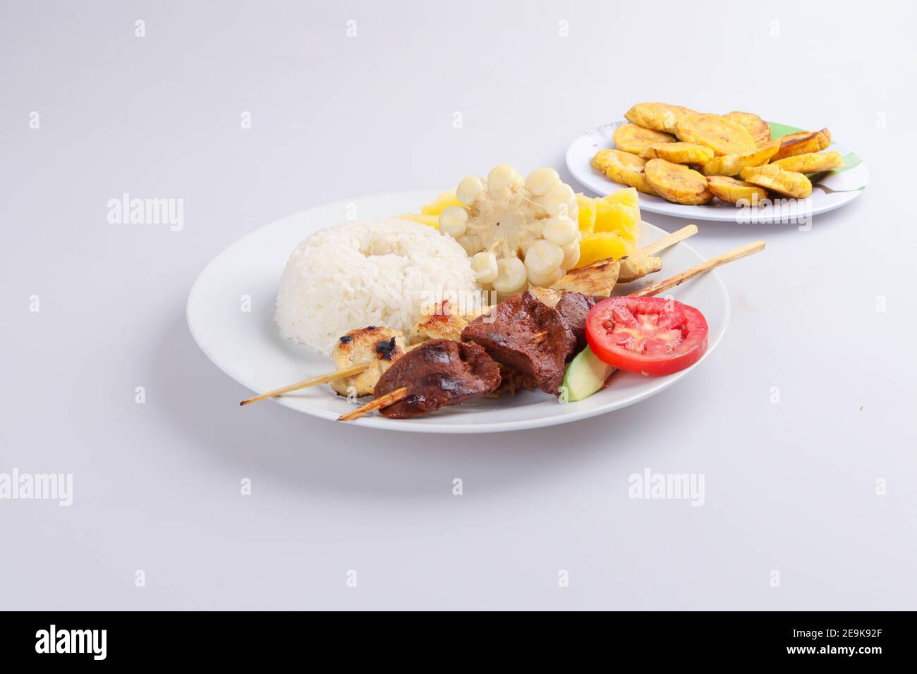 Peruvian dish called Anticucho with skewers of grilled chicken, rice ...