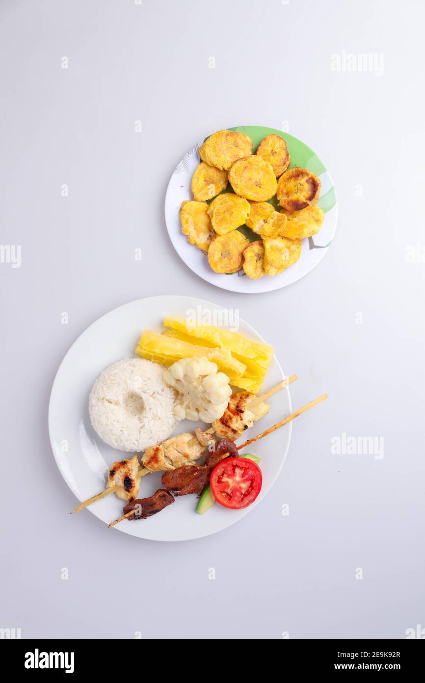 Peruvian dish called Anticucho with skewers of grilled chicken, rice ...