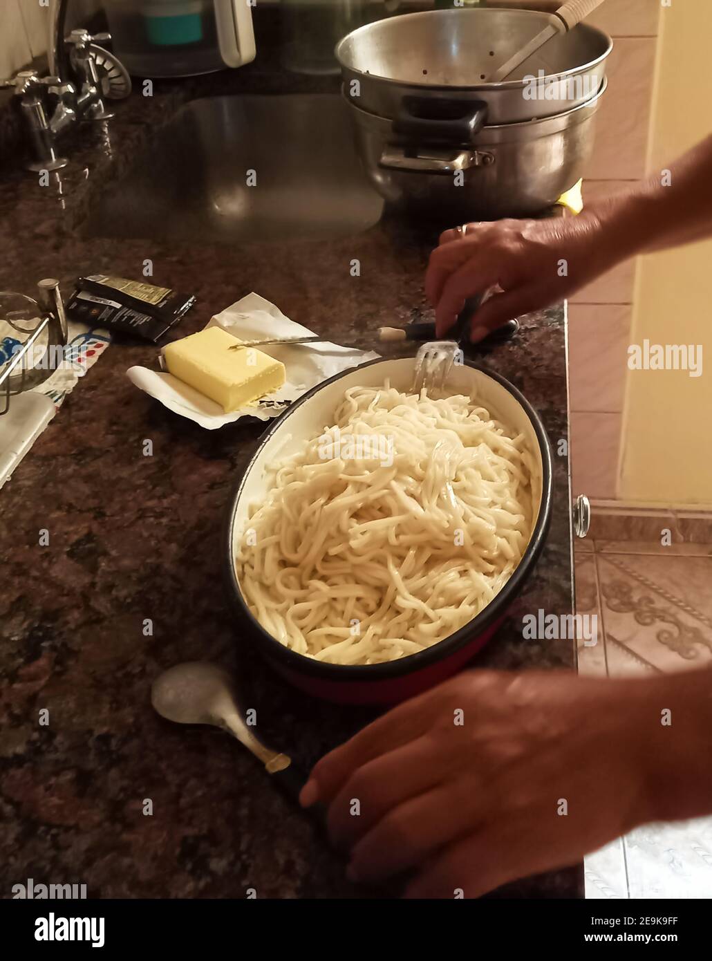 Cooking tasty homemade noodles (taglierini) pasta with butter in the ...