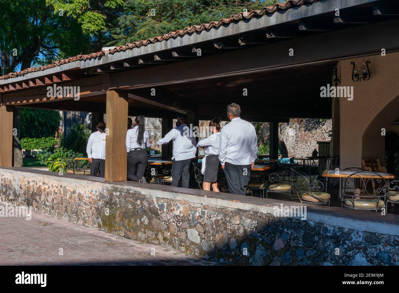 waiters wearing masks waiting for customers to arrive at the restaurant ...