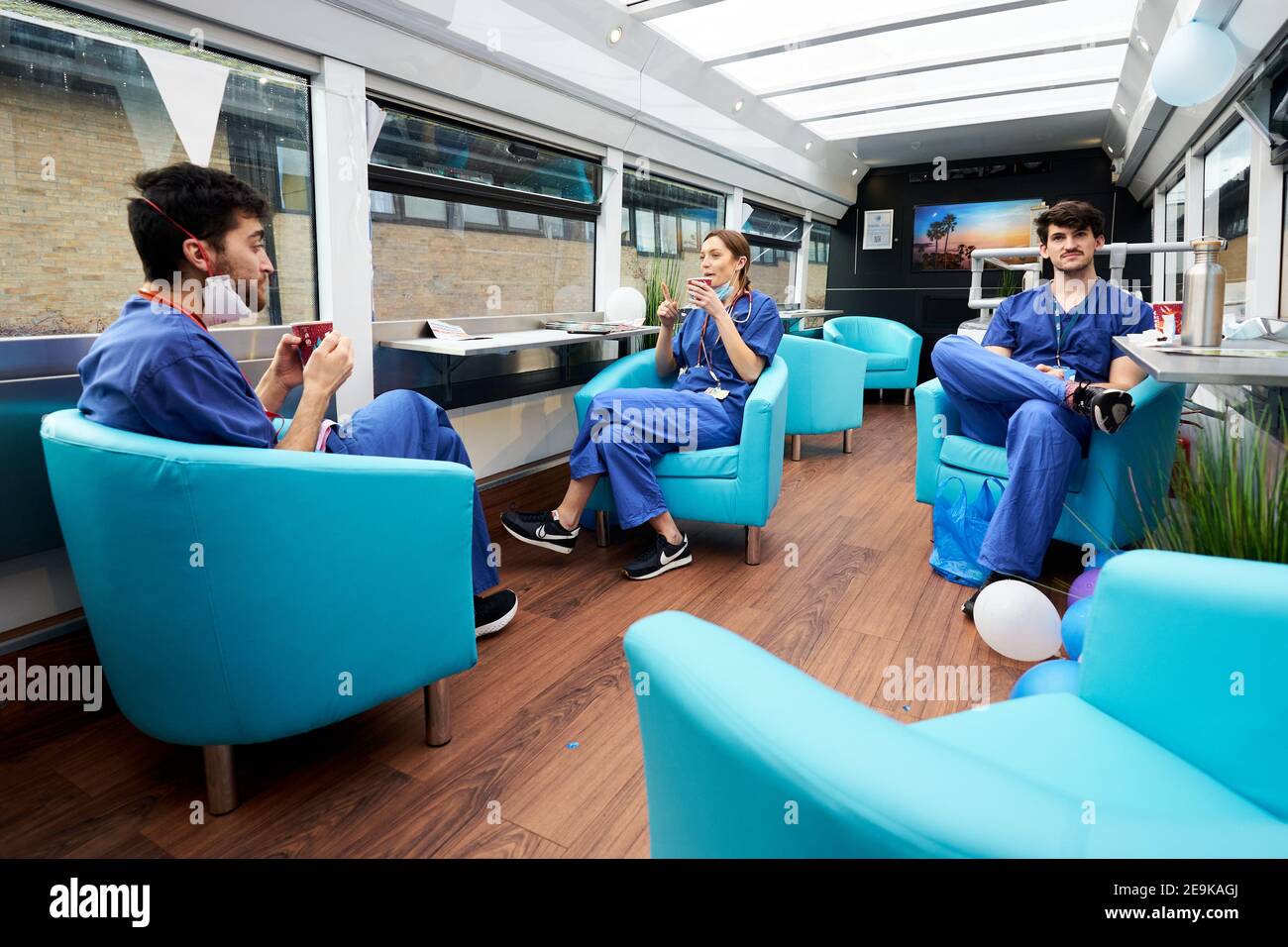 Health workers sit onboard the Well-being bus at Homerton University ...