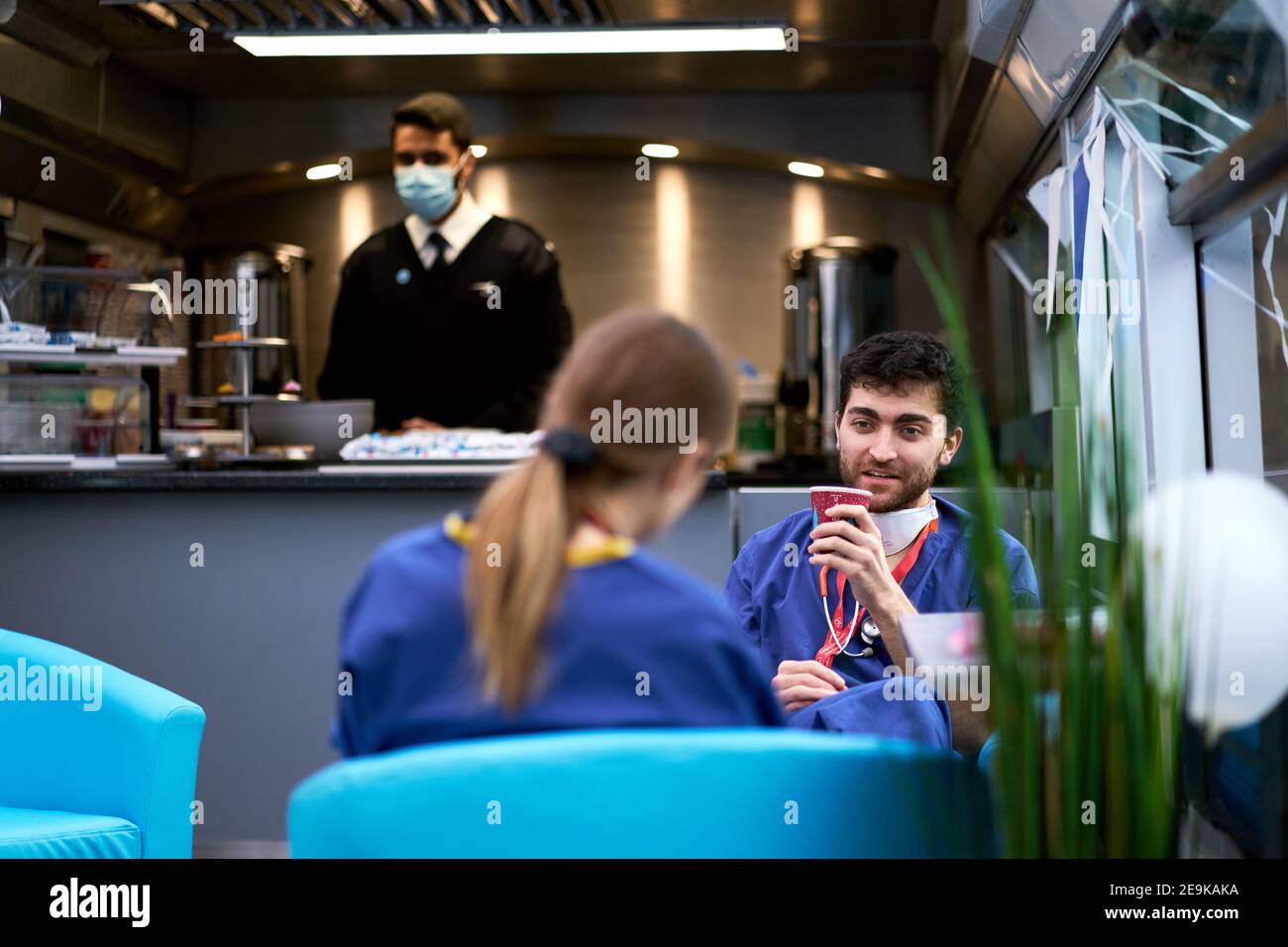 Health workers sit onboard the Well-being bus at Homerton University ...