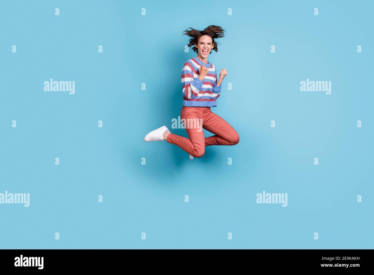 Full length body size photo of jumping high young female winner ...