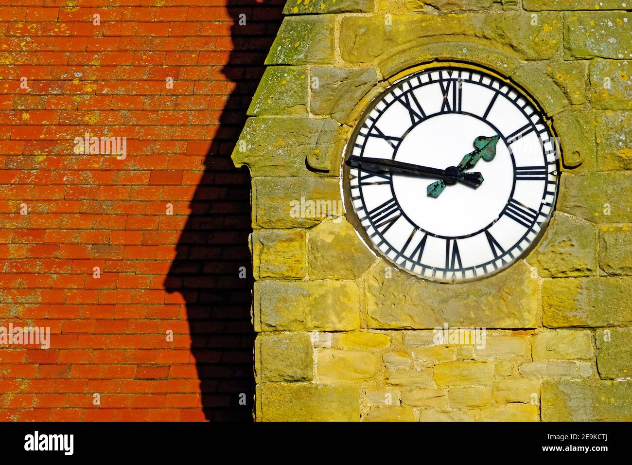 Vintage village clock with stone work and roof tiles Stock Photo - Alamy