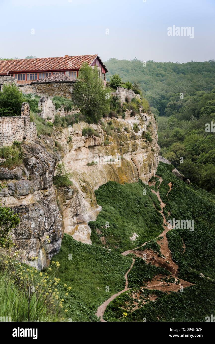 Medieval building on a high cliff above the mountain valley in the ...