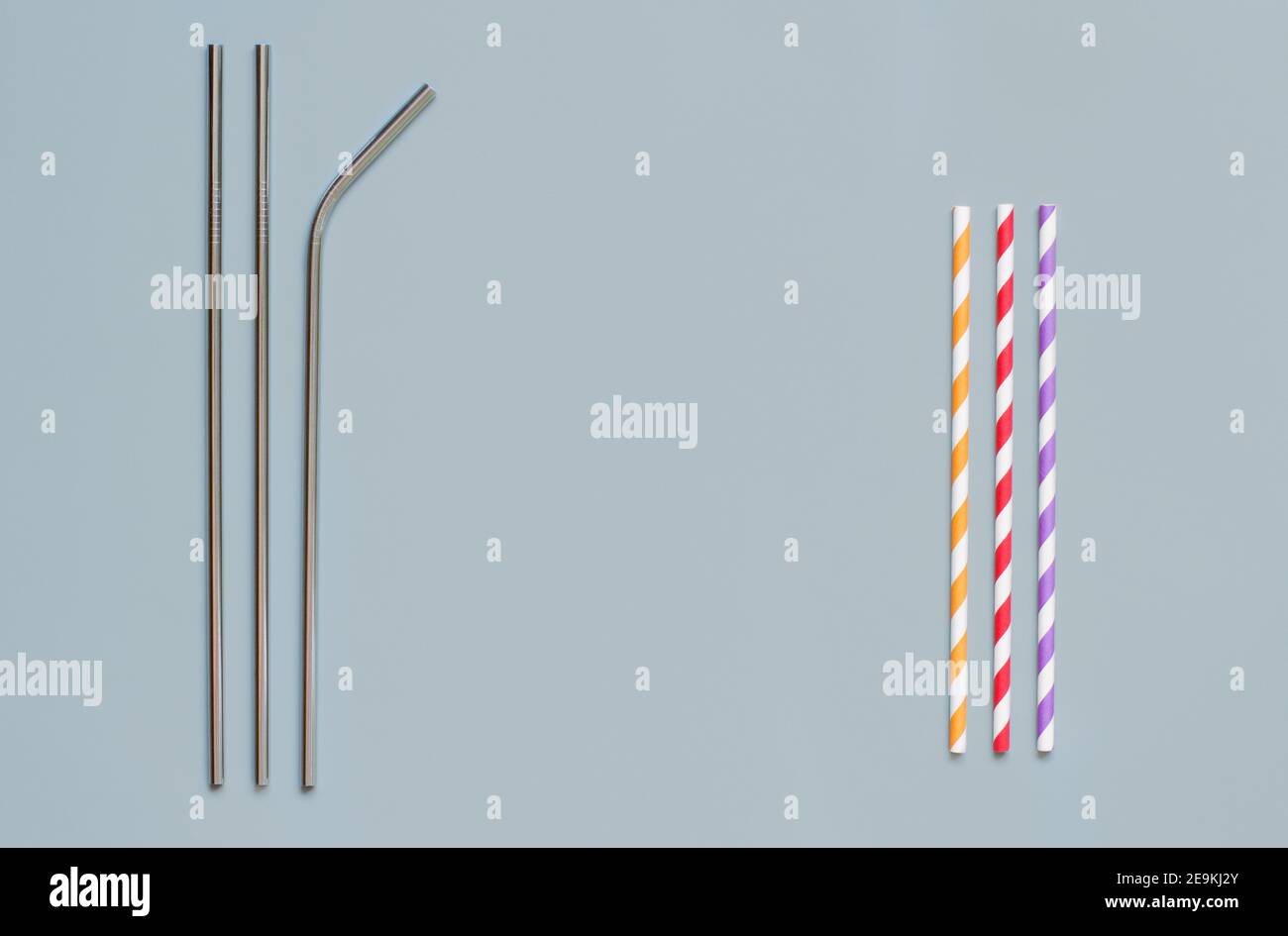 Steel and paper drinking straws on grey background top view with copy ...