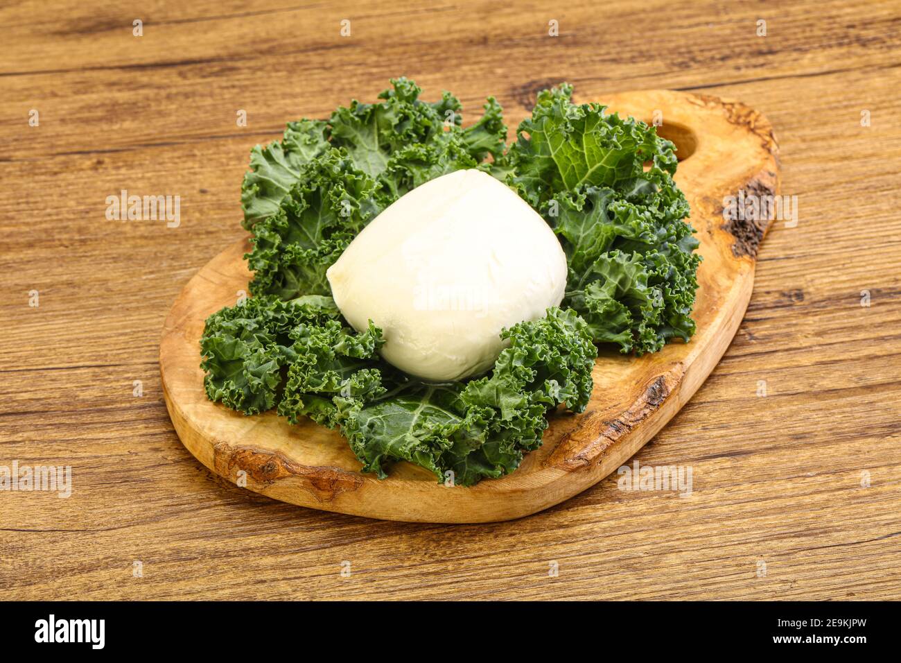 Soft Italian mozzarella cheese over board Stock Photo - Alamy