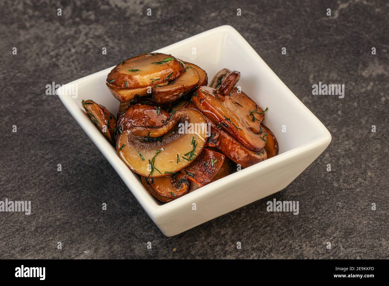 Roasted champignon with herbs and spices in the bowl Stock Photo - Alamy