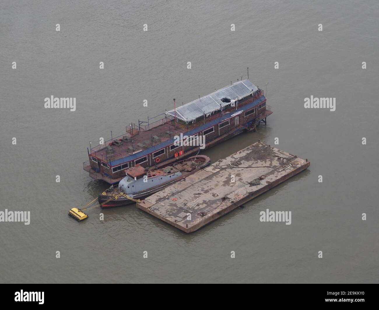 aerial view of a floating building and dock with a small industrial ...