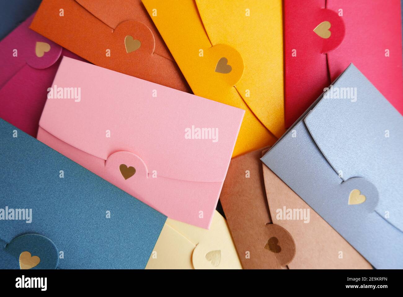 Bunch of colorful envelopes decorated with golden Stock Photo - Alamy