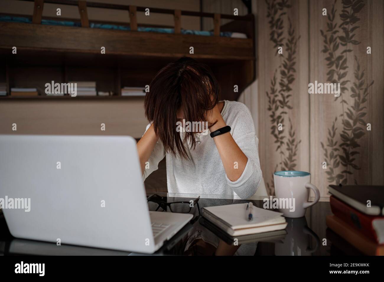 Thoughtful doubtful asian female student worker looking away thinking ...
