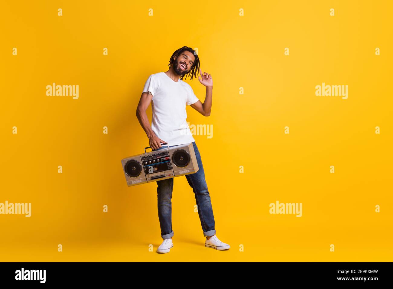 Full length photo of young black guy finger hand hold vintage radio ...