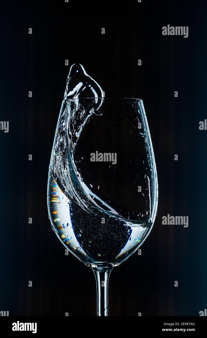 Clear water in a glass, delicious spring transparent with a splash in ...