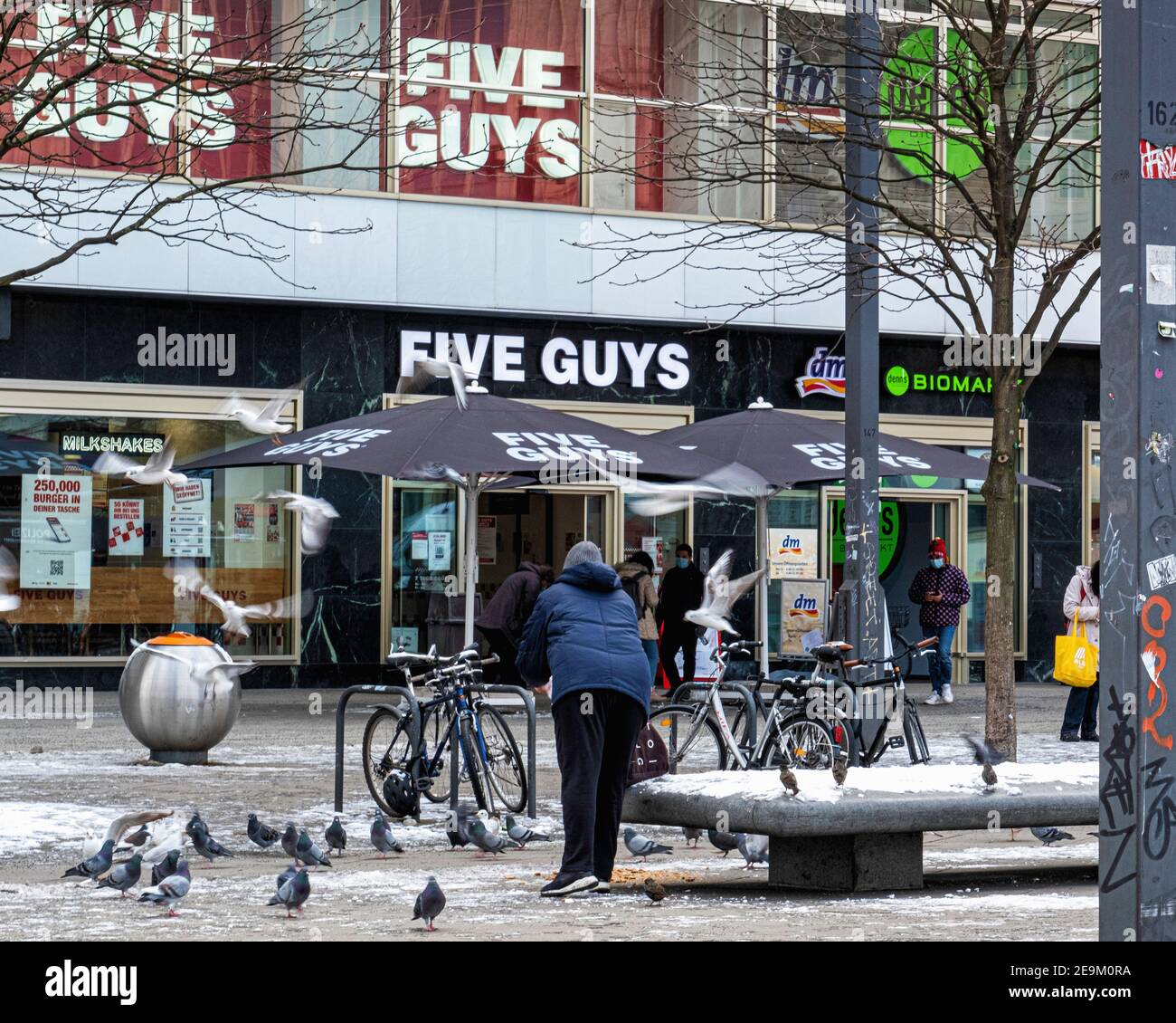 Man feeds hungry birds outside closed shops during COVID-19 lockdown ...