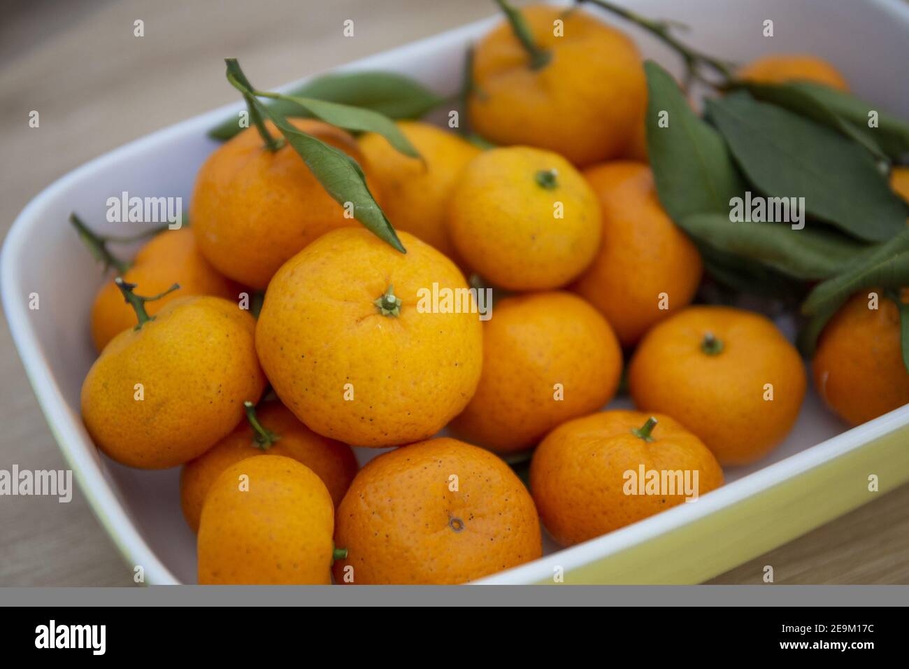 High angle shot of fresh mandarines in a white ceramic bo Stock Photo ...