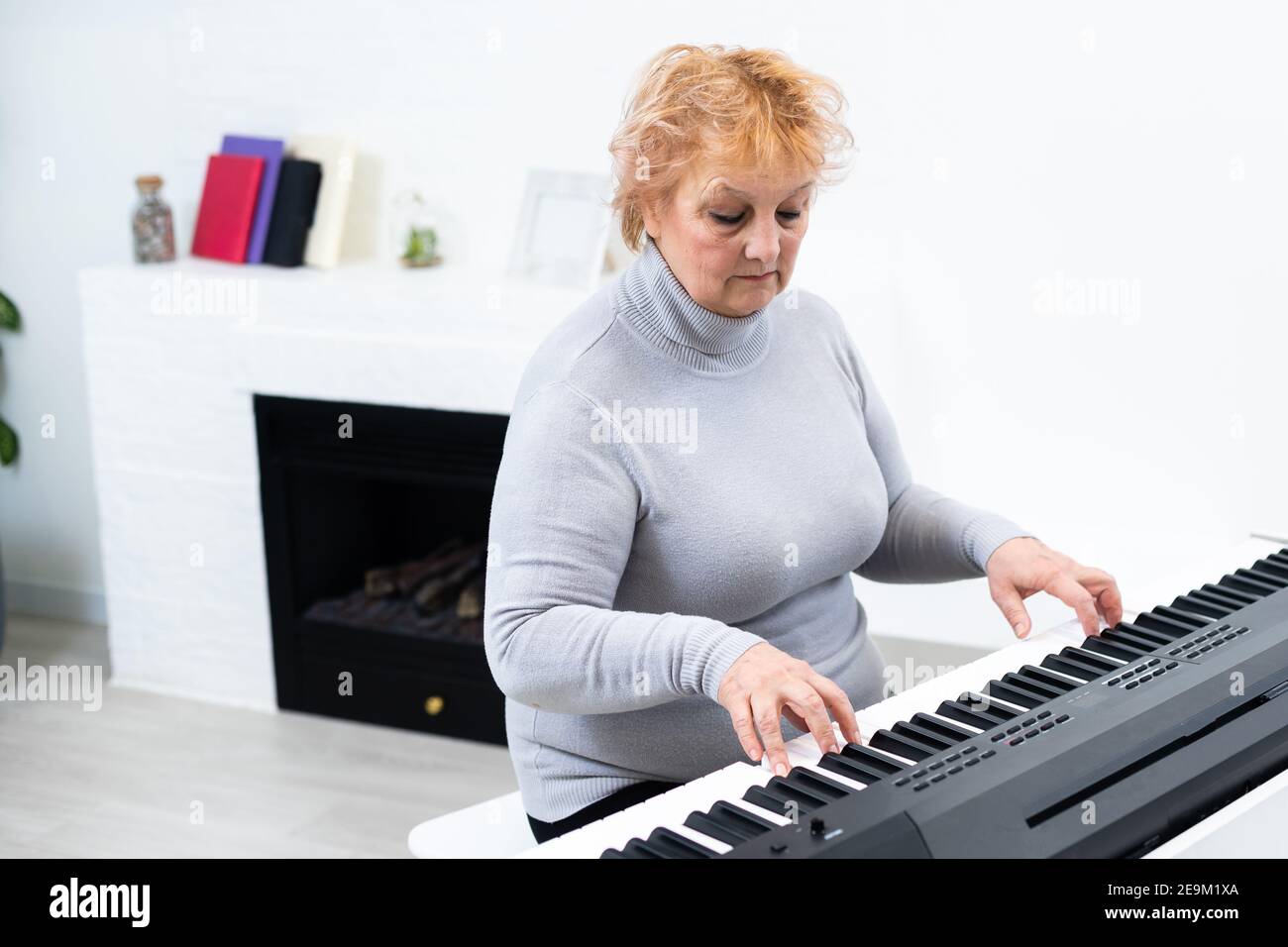 Old lady playing piano hi-res stock photography and images - Alamy