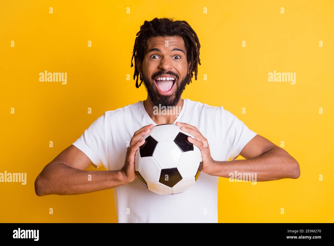 Photo of ecstatic dark skin model guy hold leather ball watch match ...