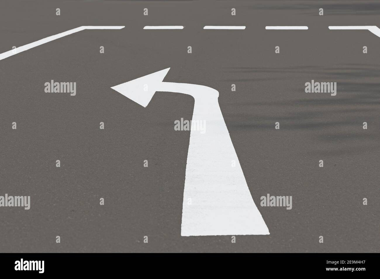 Road with turn left arrow Stock Photo - Alamy