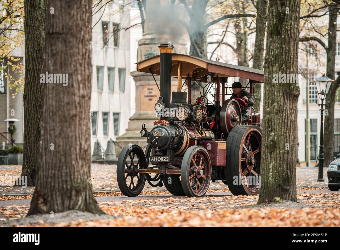 Vintage industrial Steam powered traction engine driving on public road ...