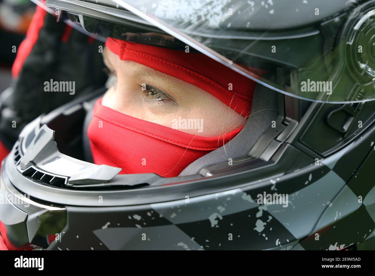 Symbol image: Female race car driver wearing helmet and balaclava ...