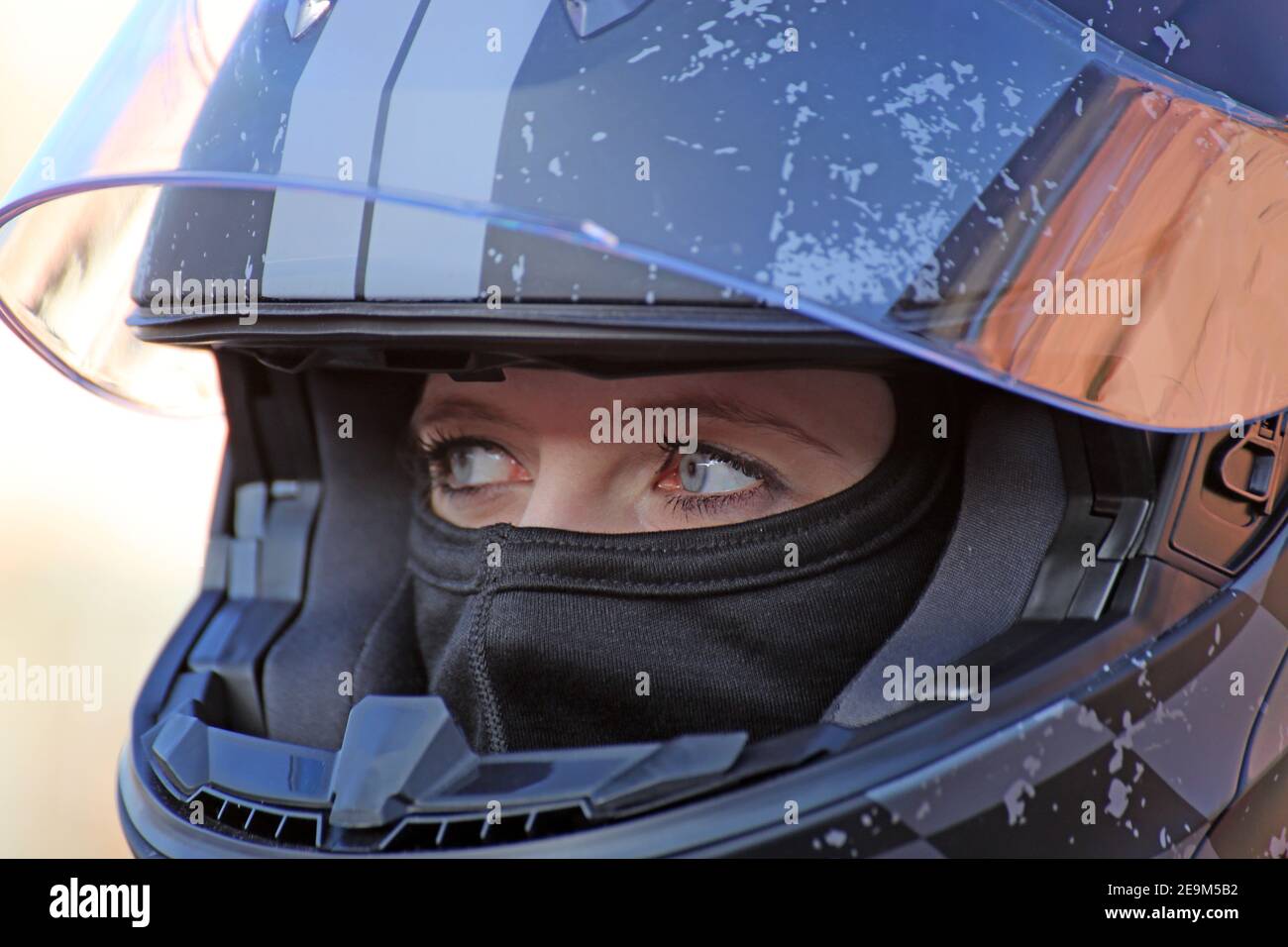 Symbol image: Female race car driver wears helmet and balaclava (model ...
