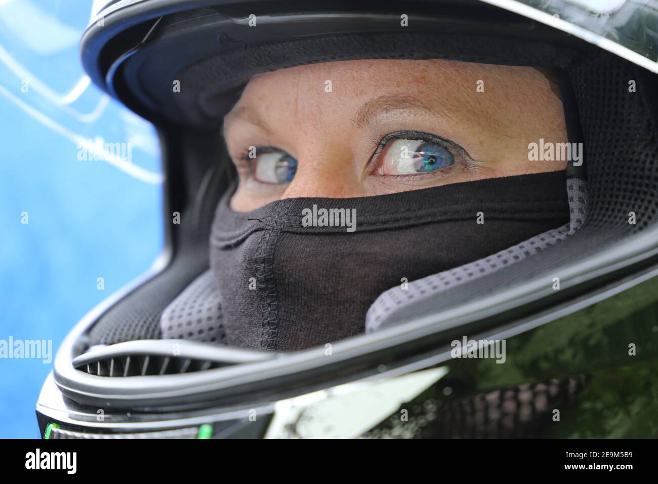 Symbol image: Female race car driver wears helmet and balaclava (model ...