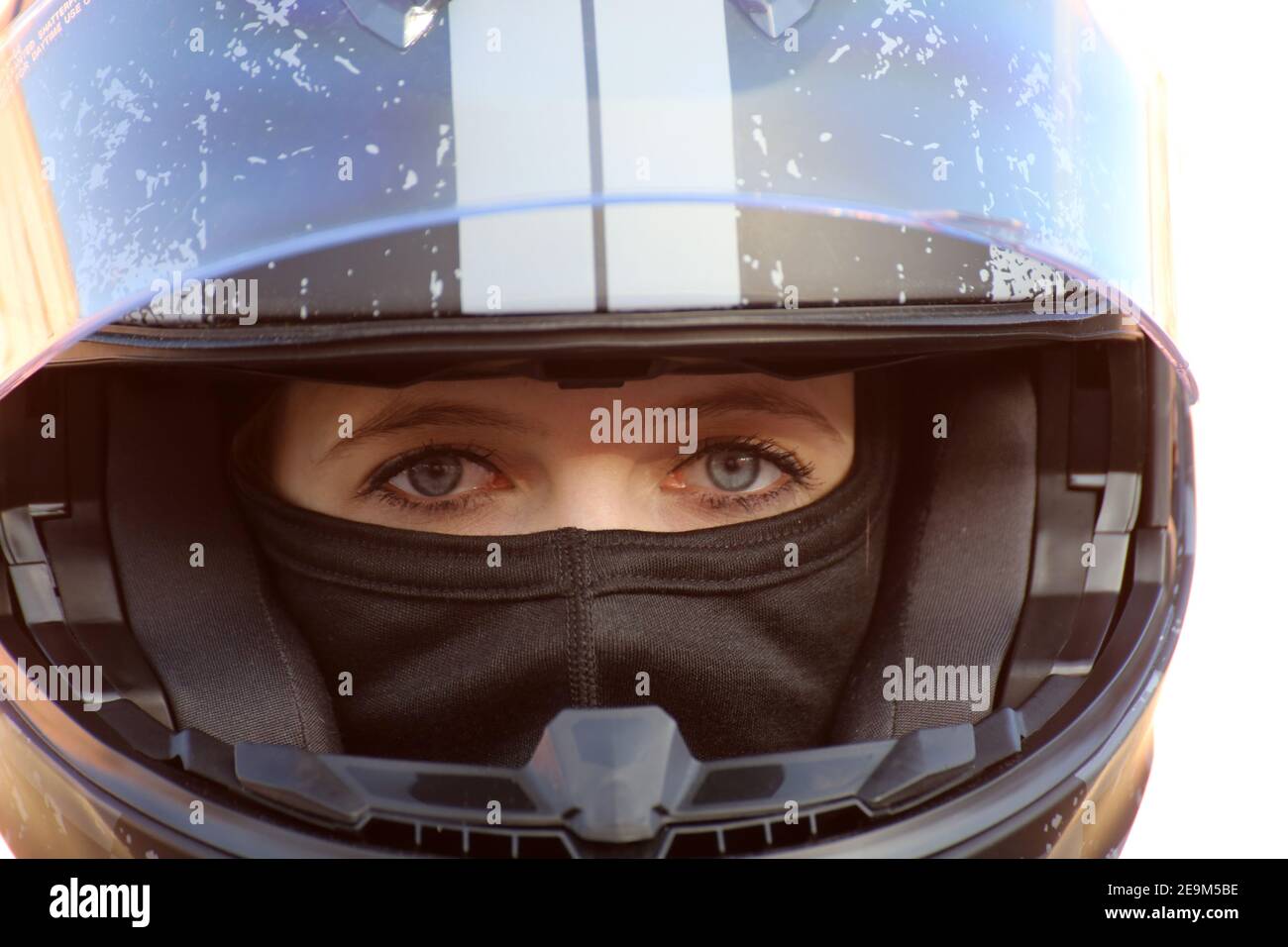 Symbol image: Female race car driver wears helmet and balaclava (model ...