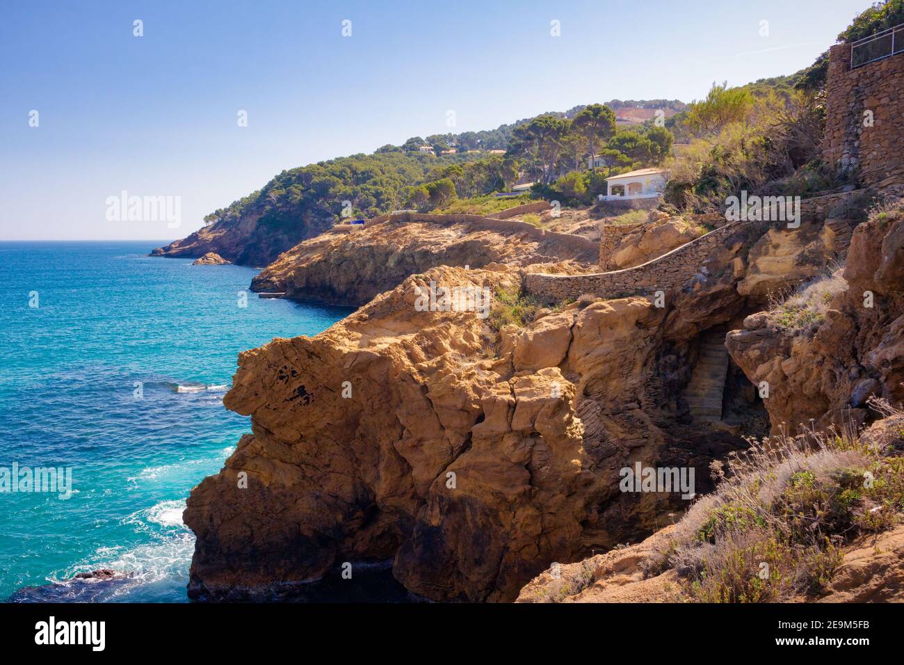 View of the coastal path of Sa Riera beach to Cala S'Antiga and Punta ...
