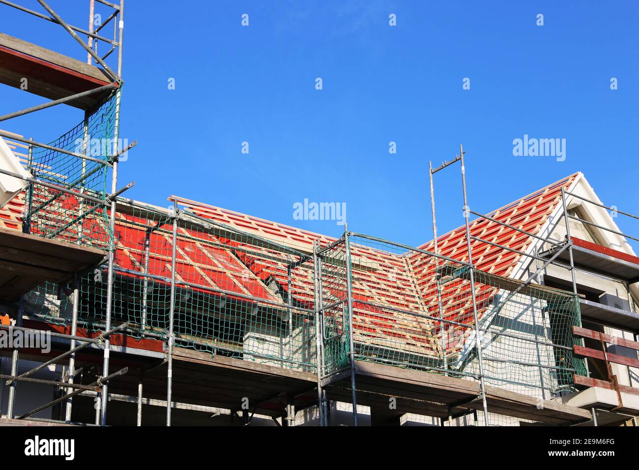 New onstruction of a multi-family house. The roof is being tiled Stock ...