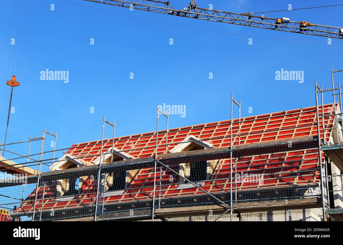 New onstruction of a multi-family house. The roof is being tiled Stock ...