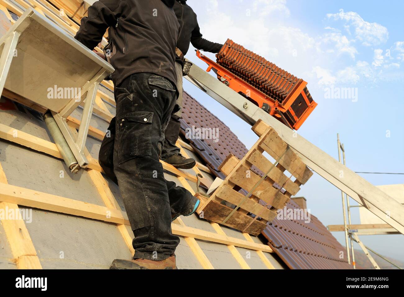 Roofing work, new covering of a tiled roof Stock Photo - Alamy