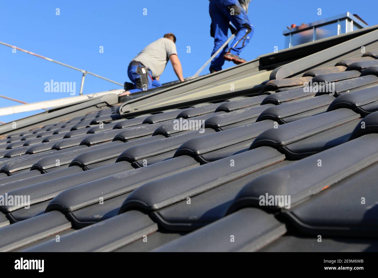 Roofing work, new covering of a tiled roof Stock Photo - Alamy