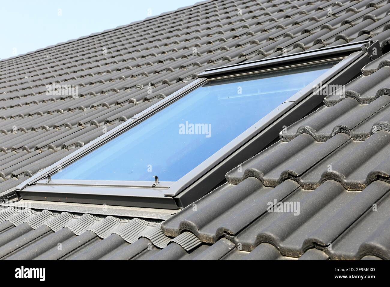 Skylight on a new tiled roof Stock Photo - Alamy