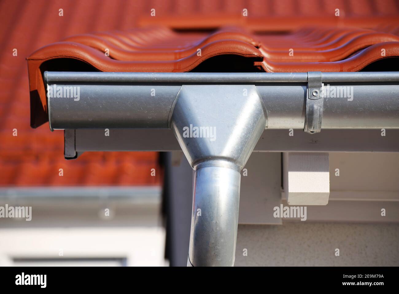 Roof gutter on a new tiled roof Stock Photo - Alamy