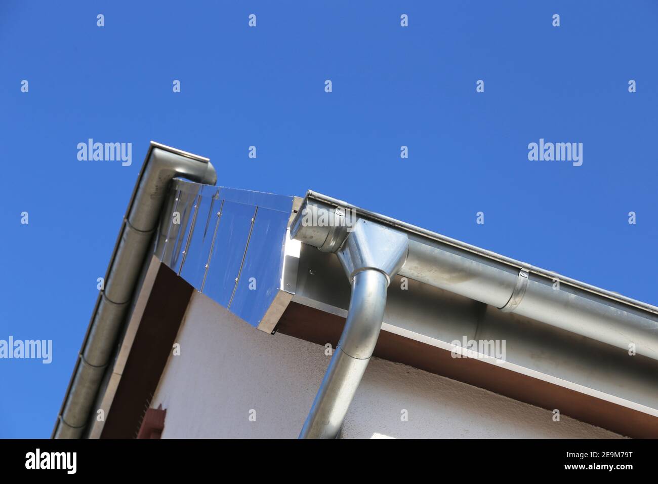 Roof gutter on a new tiled roof Stock Photo - Alamy