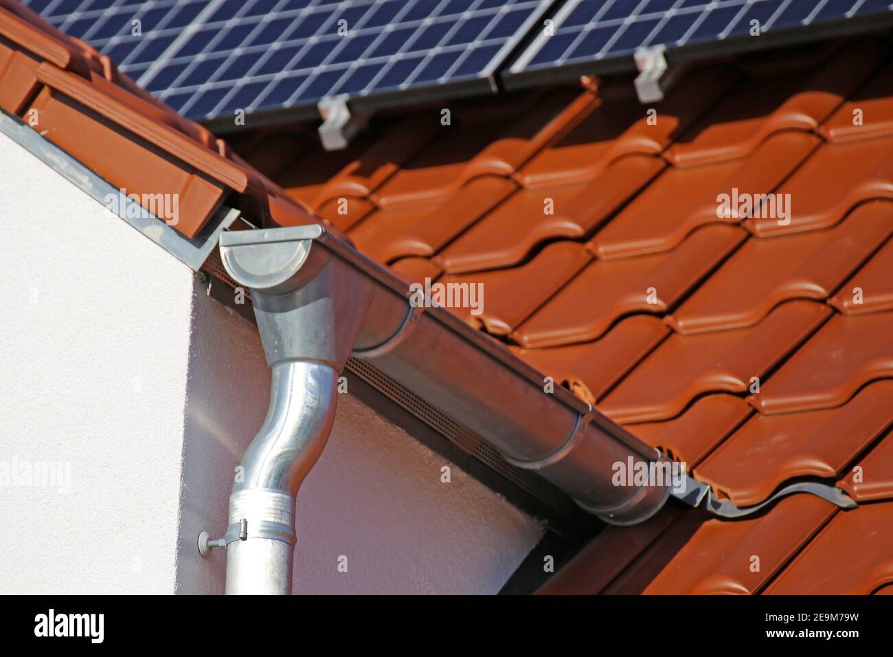 Roof gutter on a new tiled roof Stock Photo - Alamy
