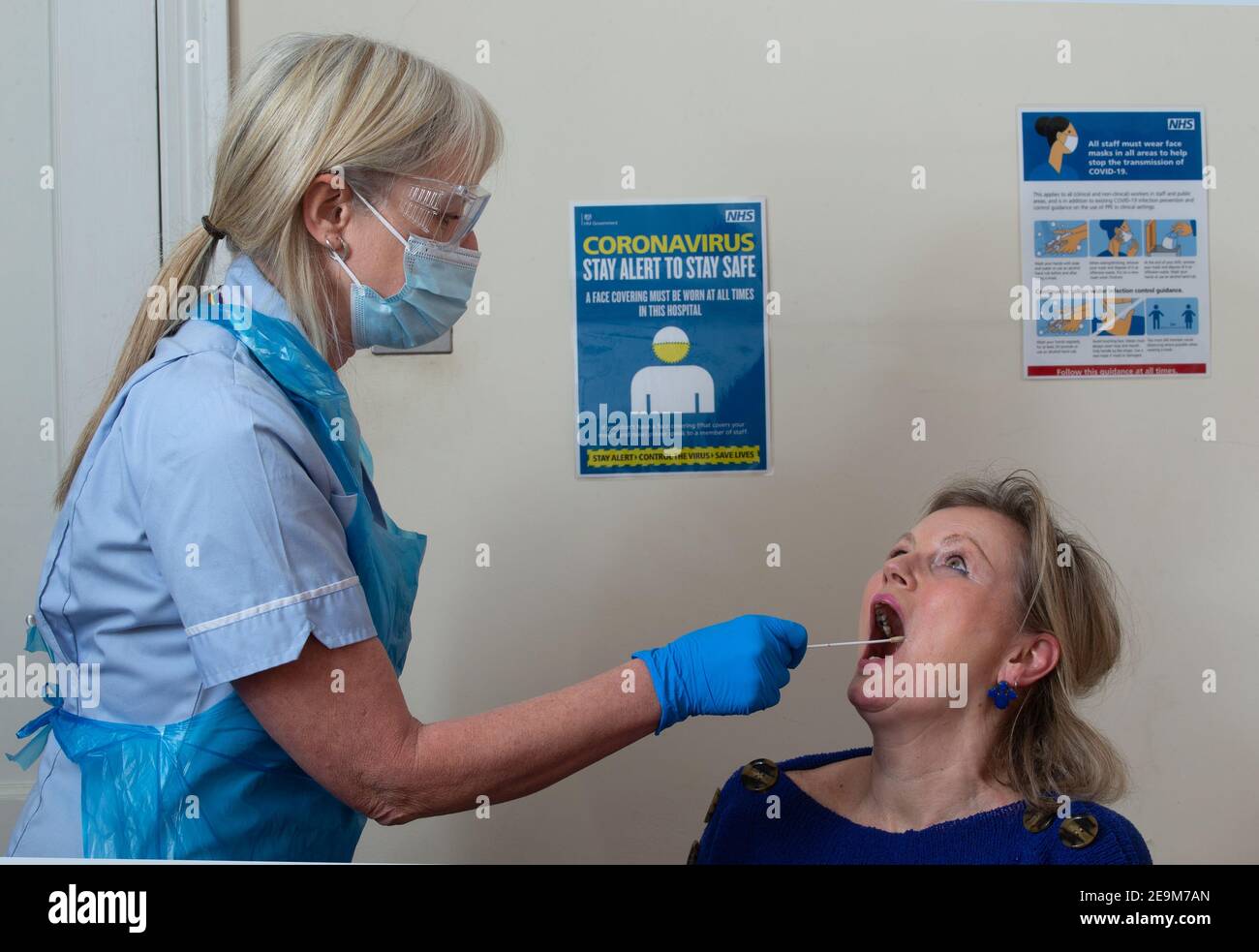 An NHS nurse gives a patient a swab test as part of a rapid Lateral ...