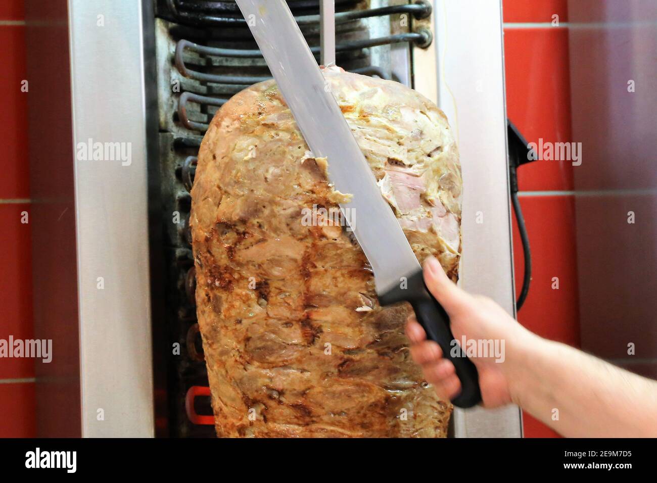 Doner kebab on the rotating spit Stock Photo - Alamy