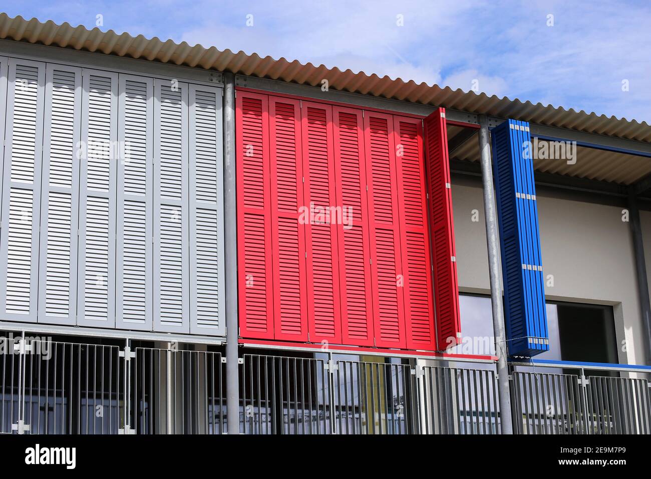 Large modern folding sliding shutters on a building Stock Photo - Alamy