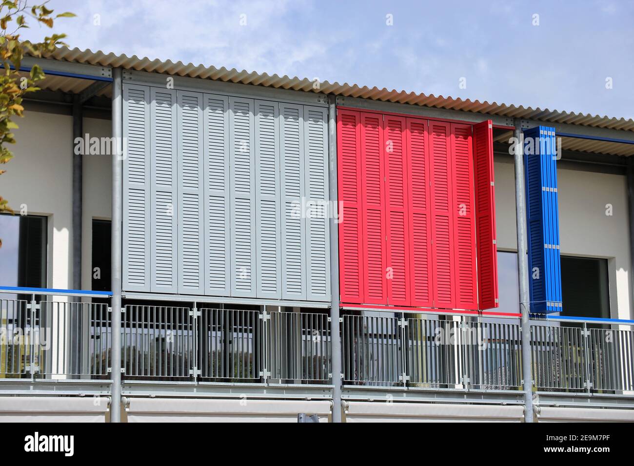 Large modern folding sliding shutters on a building Stock Photo - Alamy